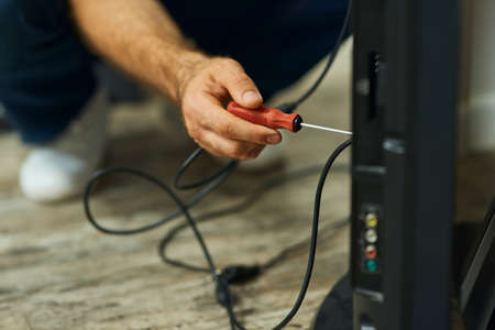 Handy home repair. Close up shot of hand of a repairman using a ...