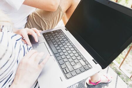 Woman using laptop computer outside the office. Freelance work concept ...
