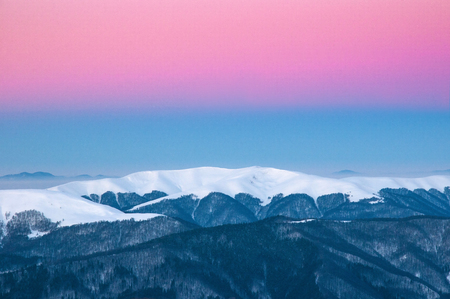 Wonderful pink sunrise in the Carpathians in the winter. Snow-covered ...