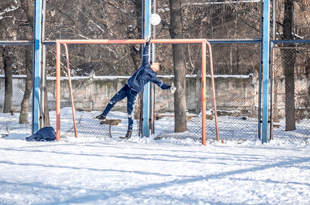 Playing football on the snow in the winter - Stock Image - Everypixel