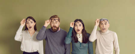 Four people gasp in surprise and take off their glasses when they see ...