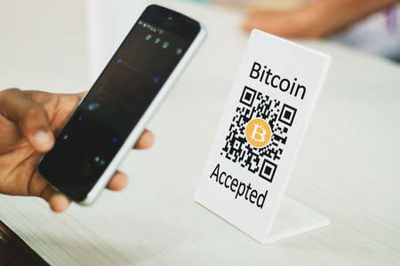 Close up of hands by using mobile phone Scaning Bitcoin QR code for ...