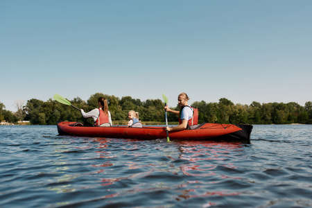 Young european family floats on kayak in lake - Stock Image - Everypixel