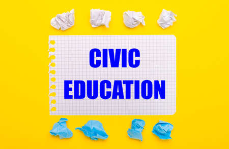 On a yellow background, white and blue crumpled pieces of paper and a ...