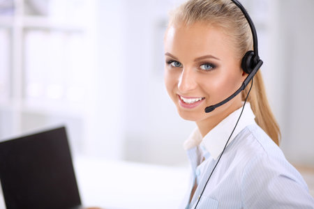 portrait of a customer service agent sitting at office - Stock Image ...