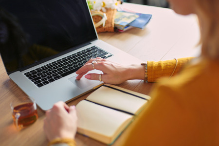 Young woman holding credit card and using laptop computer. Online ...