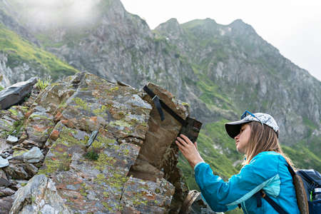 Young woman scientist ecologist zoologist setting up a trap camera in a ...