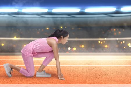 Asian runner woman ready to run on the running track on the stadium ...