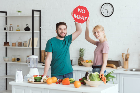 couple of vegans showing no meat sign at kitchen - Stock Image - Everypixel