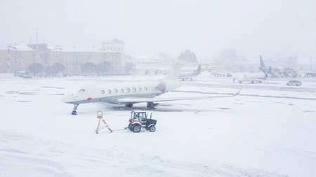 Snow covered commercial plane at the airport. Close-up of the plane ...