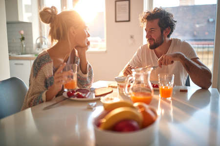 A young couple in love having romantic moments while having a breakfast ...