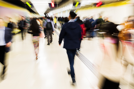 people walking in the passage of an underground station with camera ...