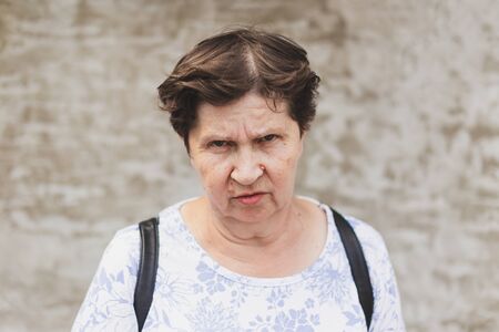 Portrait of senior woman with an angry facial expression - Upset old ...