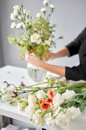 Series, step by step installation of flowers in a vase. Flowers bunch ...