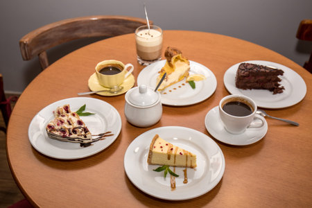 Various cakes and coffee on a table in a cafe, top view - Stock Image ...