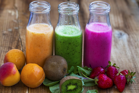 Fresh healthy three types of fruits juices or smoothies, orange, green ...