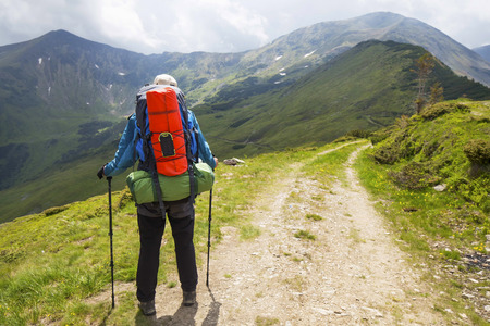 Hiker outdoor with equipment on mountain path, nature mountain ...