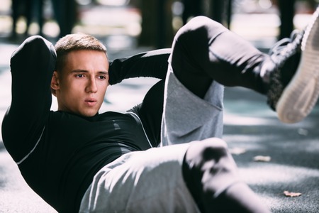 Healthy handsome active man with fit muscular body doing workout ...