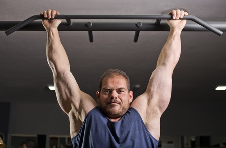 Man doing chin exercises at gym - Stock Image - Everypixel