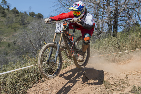 Downhill competition, Biker jumps fast in the countryside. - Stock ...