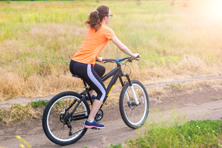 Woman is riding a bicycle, an active lifestyle. Active way of life ...