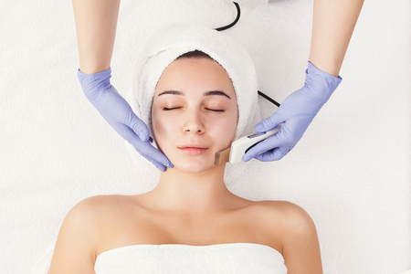 Rejuvenating facial treatment. Model getting lifting therapy massage in ...