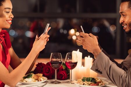 Online Dating App. Cheerful Couple Using Mobile Phones During Romantic ...