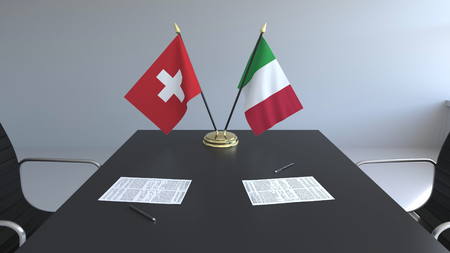 Flags of Switzerland and Italy and papers on the table. Negotiations ...