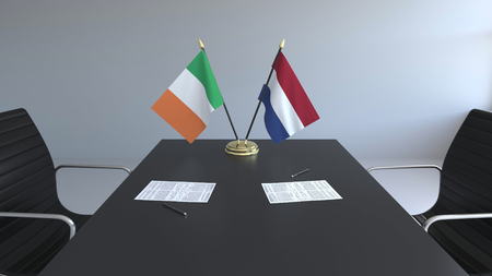 Flags and papers on the table. Negotiations and signing a contract ...