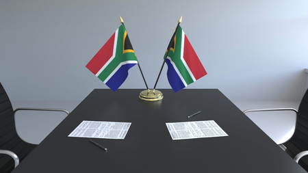 Flags and papers on the table. Negotiations and signing a contract ...