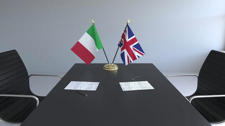 Flags and papers on the table. Negotiations and signing a contract ...