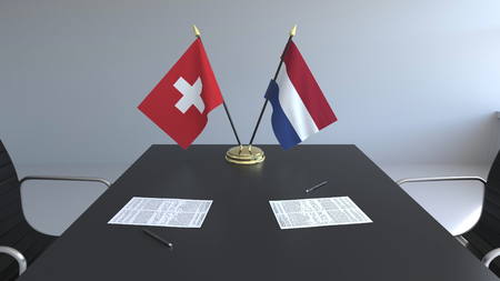 Flags and papers on the table. Negotiations and signing a contract ...