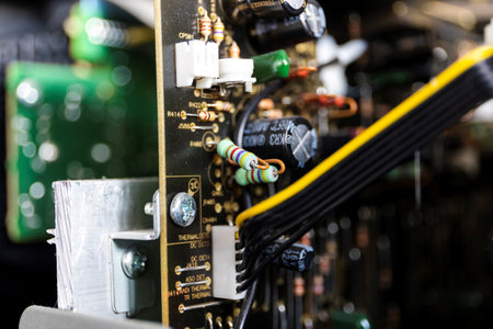 A portrait of some resistors standing a bit crooked on a black circuit ...