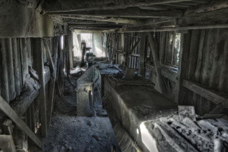 Abandoned factory. Old dusty band conveyer in old corridor of ...