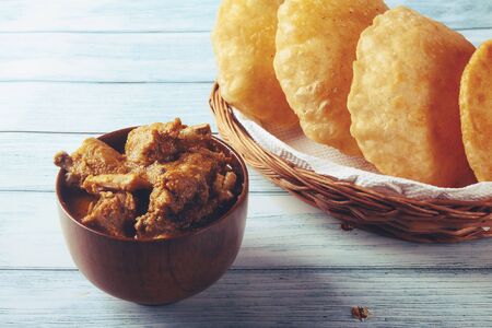 South Indian traditional food Poori or puri with country chicken curry ...