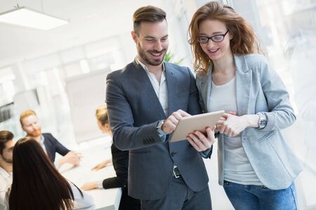 Smiling happy colleagues working at company office - Stock Image ...