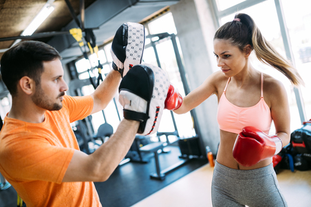 Personal trainer giving instructions in gym - Stock Image - Everypixel