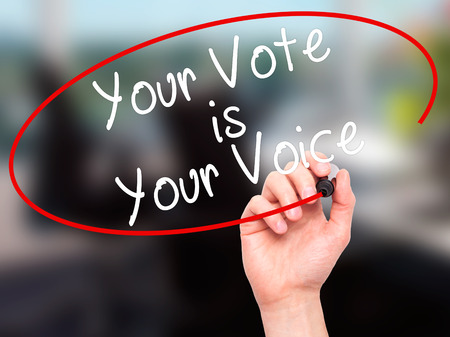 Man Hand writing Your Vote is Your Voice with black marker on visual ...