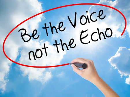 Woman Hand Writing Be the Voice not the Echo with black marker on ...