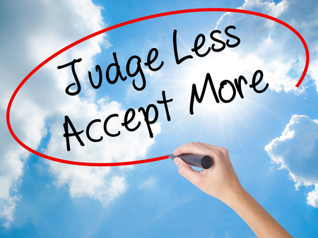 Woman Hand Writing Judge Less Accept More with black marker on visual ...