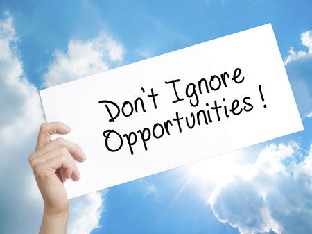 Man Hand Holding Paper with text Don't Ignore Opportunities black ...