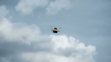 Photo of a flying on a sky delivery drone with holding a cardboard ...
