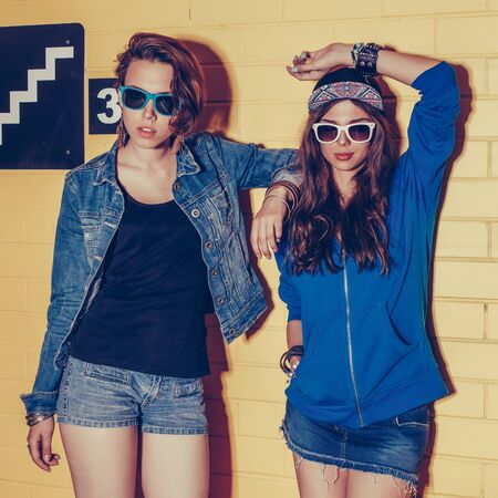 Lifestyle portrait of two beautiful best friends hipster lady wearing ...