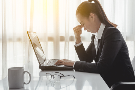 Businesswoman using computer in the office. Stress in the office ...