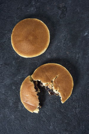 high angle view of two dorayaki, a pastry filled with adzuki bean paste ...