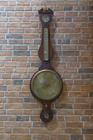 View of an old wooden wall clock, with information on the time and date ...
