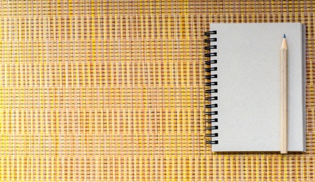 Notepad on wood board background. using wallpaper or background for ...