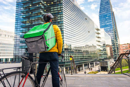 Food delivery rider on his bicycle. Image of a middle age man at work ...
