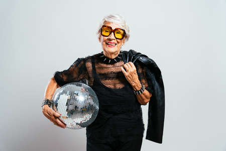 Beautiful and elegant old influencer woman. Cool grandmother posing in ...