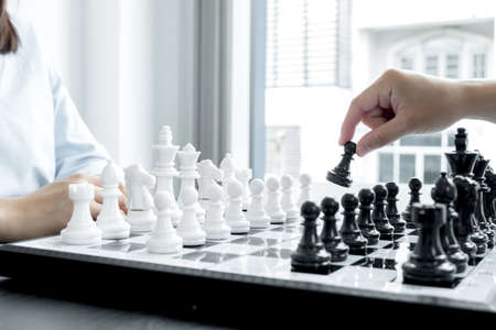 The hands of businessmen moving chess in chess competitions demonstrate ...